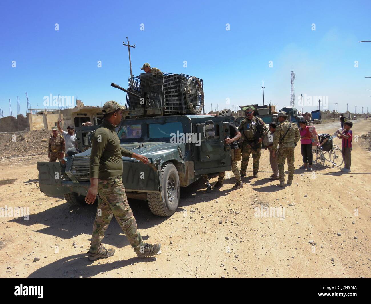 Mosul. 25th May, 2017. Several Iraqi soldiers stand by an armored ...