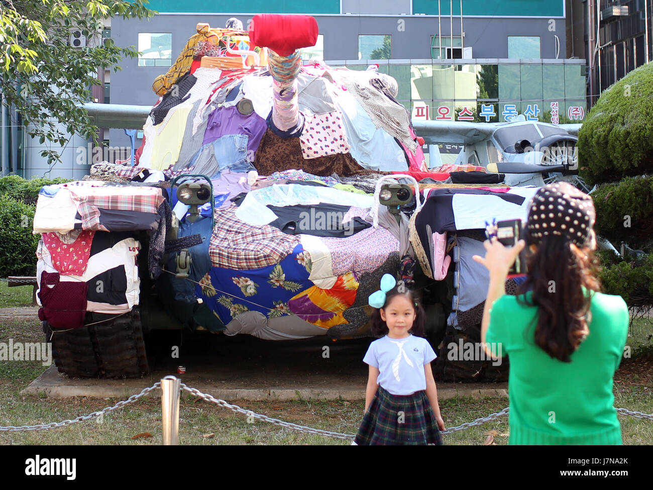 Dressed tank A tank is shown covered in clothes at an exhibition in ...