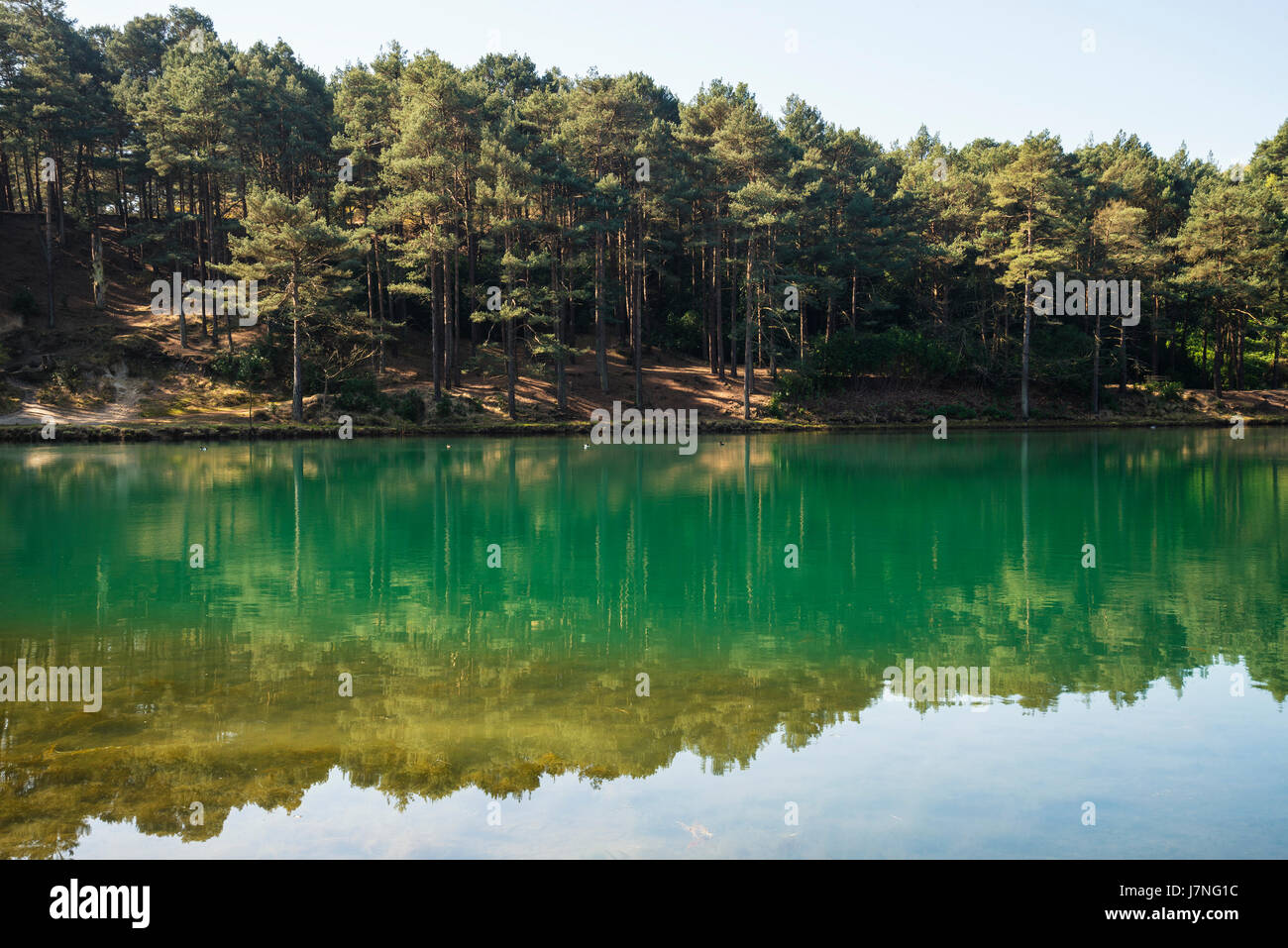 Beautiful landscape image of old clay pit quarry lake with unusual ...