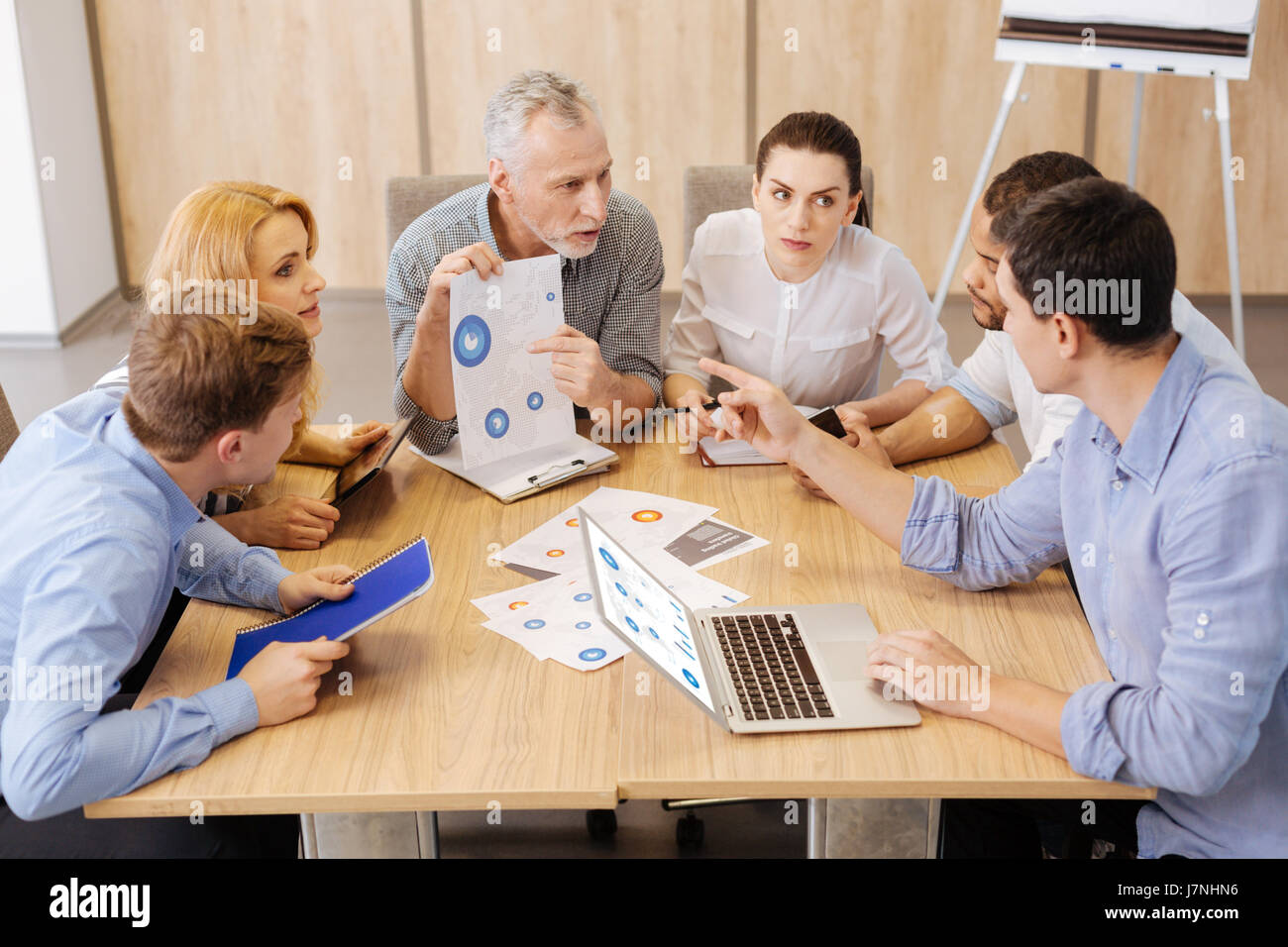 Professional team of office workers discussing their project Stock ...