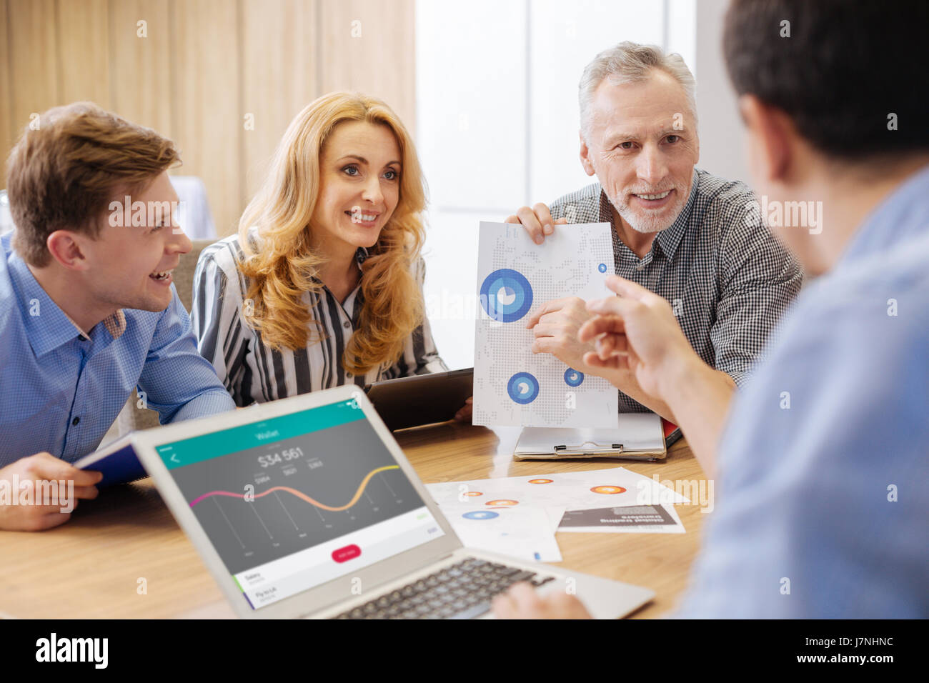 Professional nice colleagues discussing trading market Stock Photo - Alamy