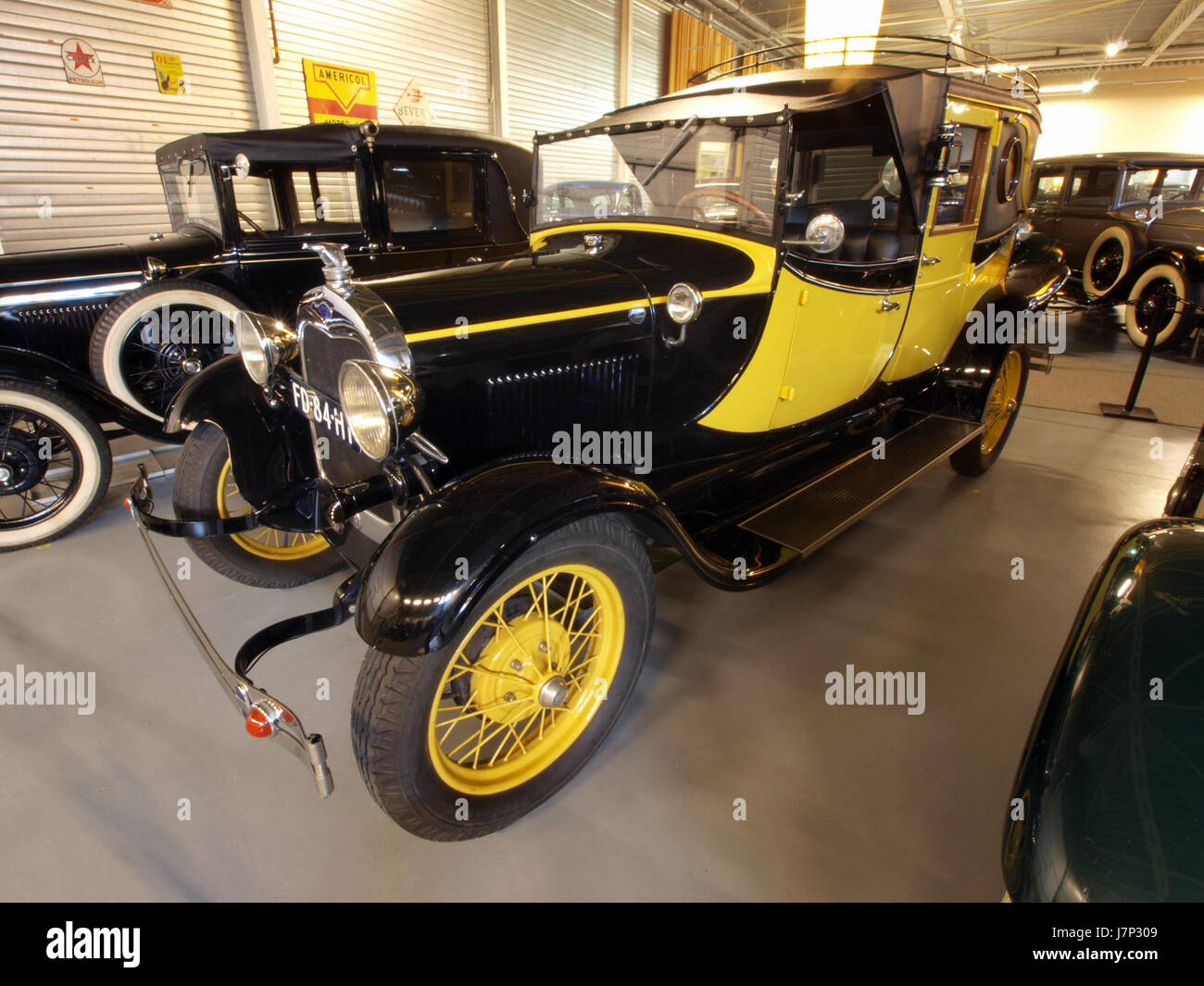 This photograph shows a 1928 Ford A Landaulette, a classic car model ...