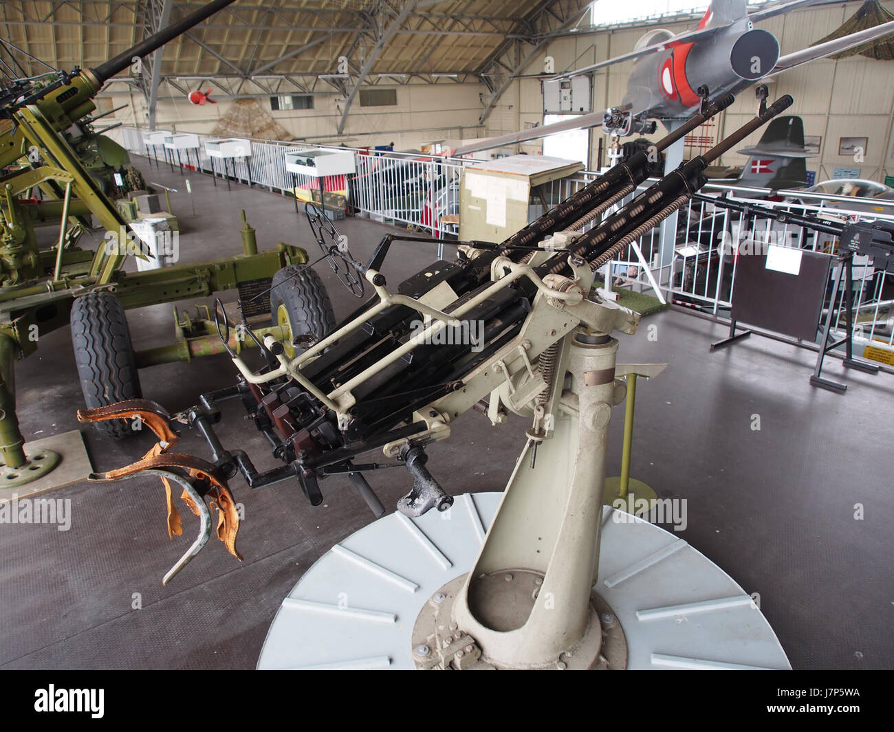 This image shows the 12.7mm Madsen Saetter gun mounted on a naval base ...