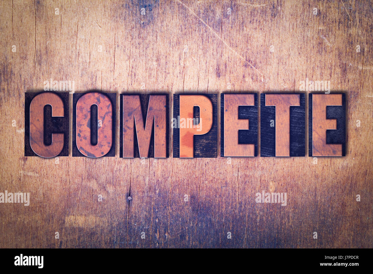 The word Compete concept and theme written in vintage wooden ...