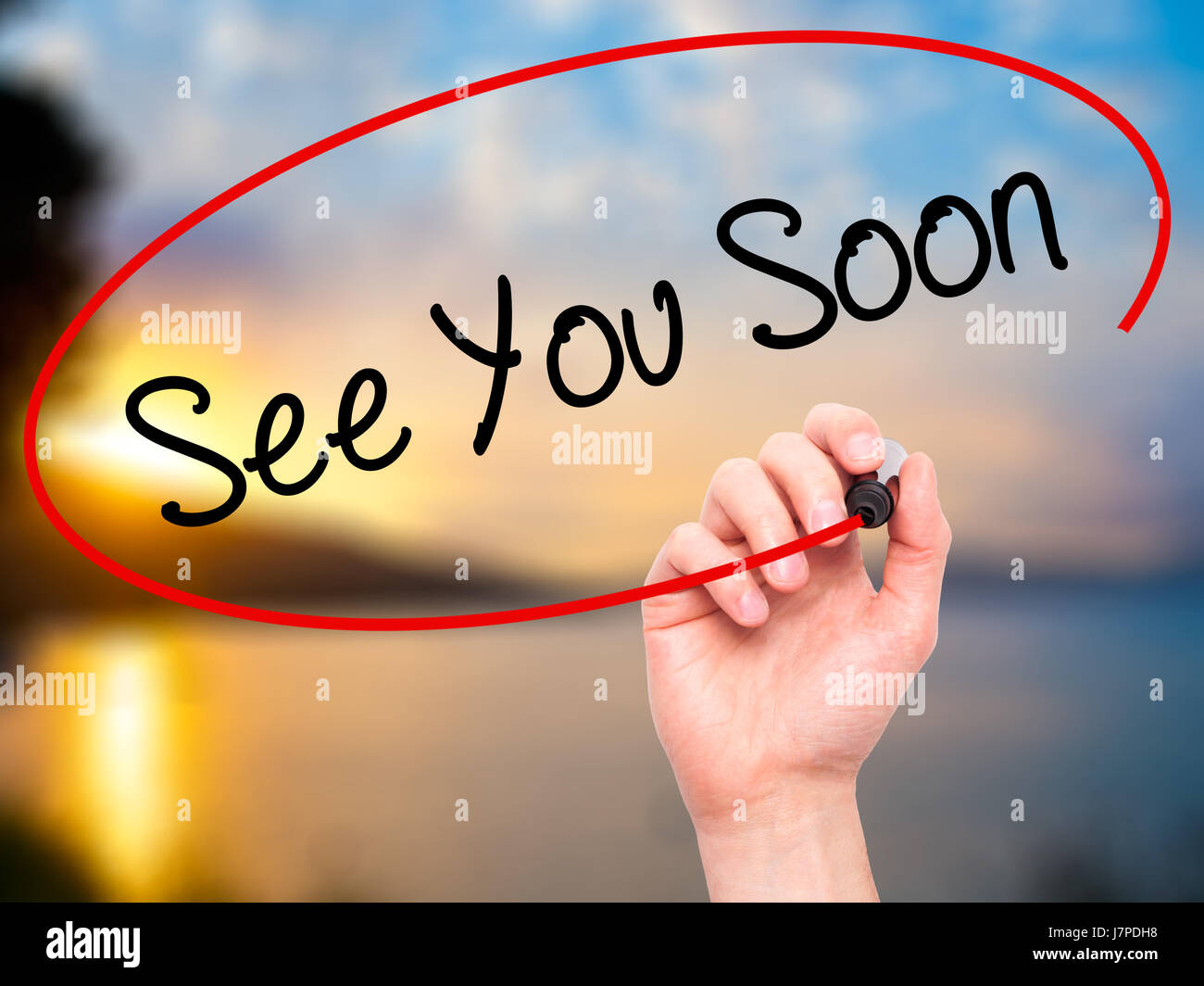 Man Hand writing See You Soon with black marker on visual screen ...