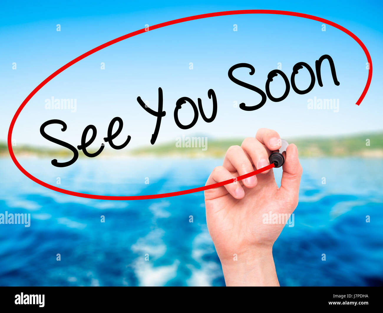 Man Hand writing See You Soon with black marker on visual screen ...