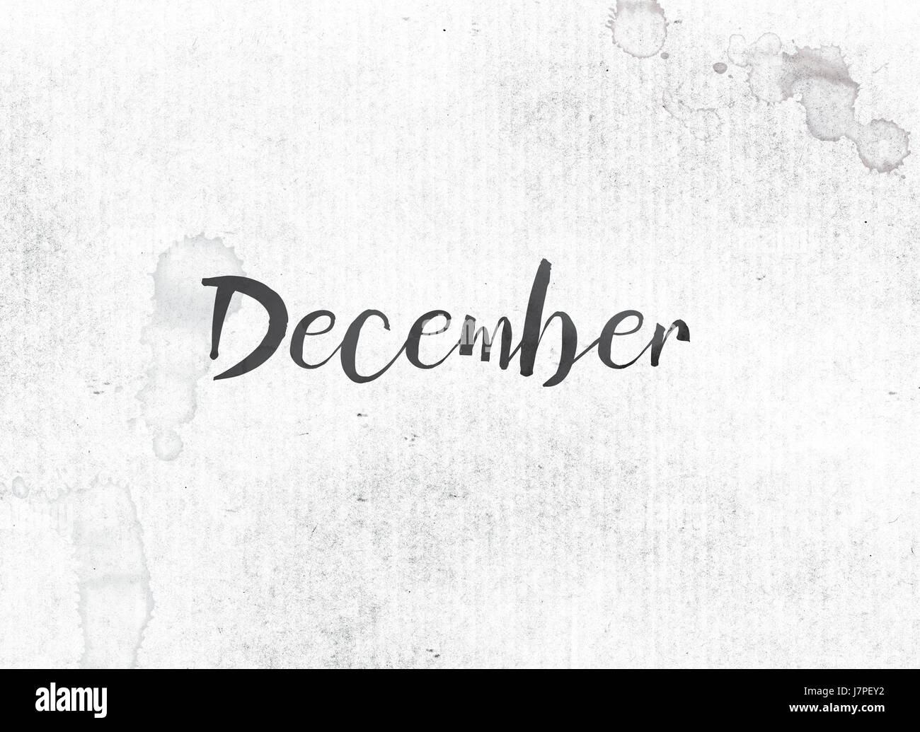 The word December concept and theme painted in black ink on a ...