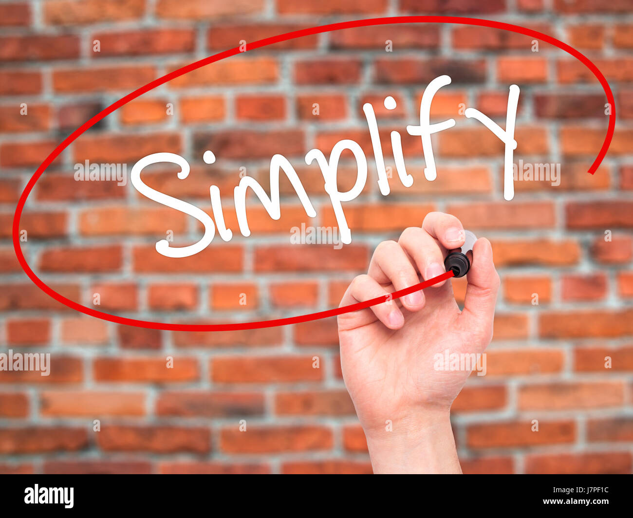 Man Hand writing Simplify with black marker on visual screen. Isolated ...