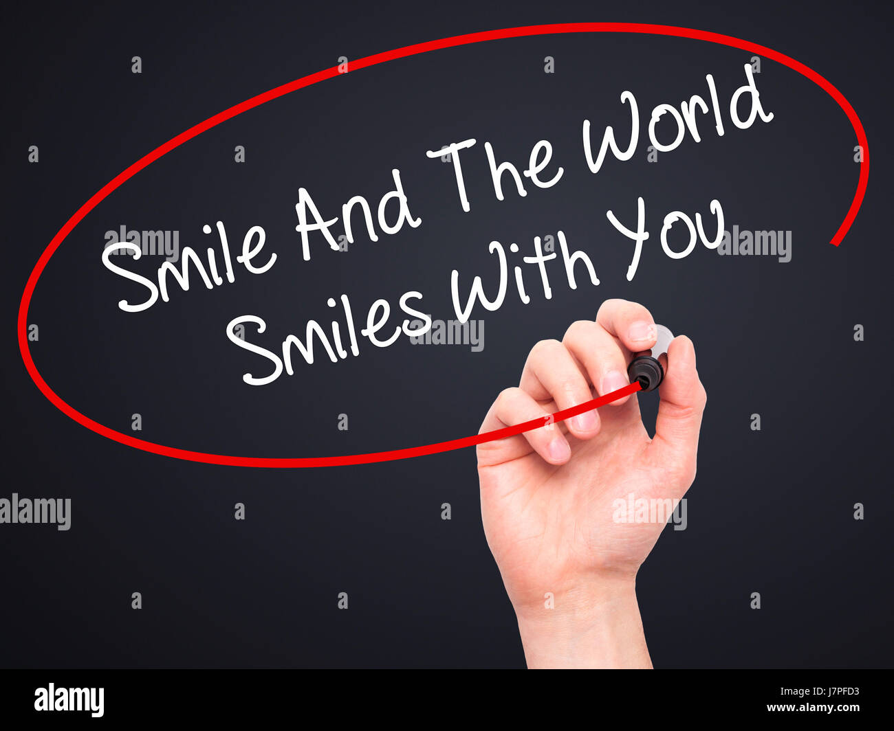Man Hand writing Smile And The World Smiles To You with black marker on ...