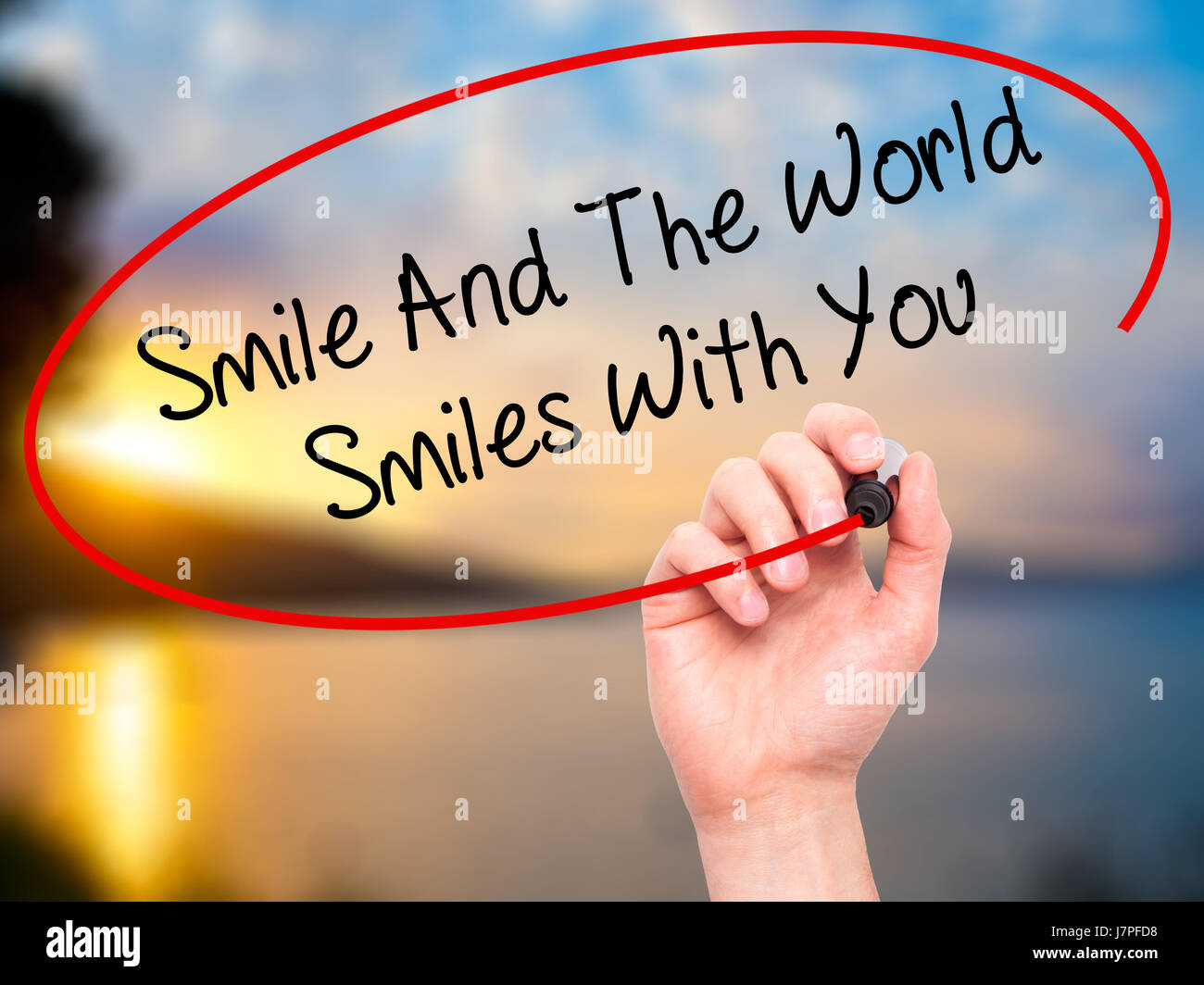 Man Hand writing Smile And The World Smiles To You with black marker on ...