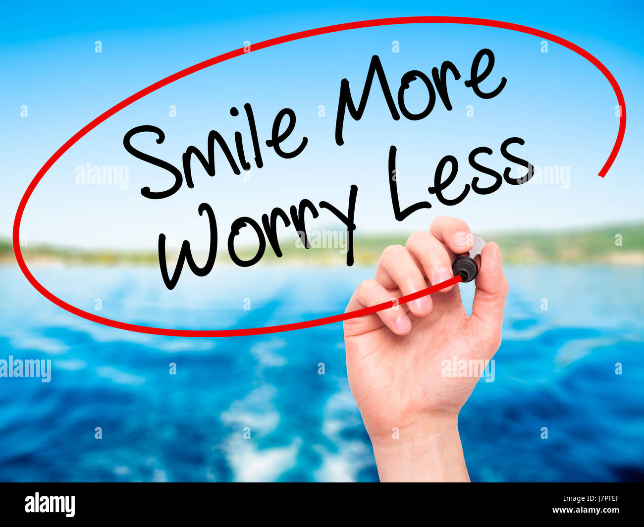 Man Hand writing Smile More Worry Less with black marker on visual ...
