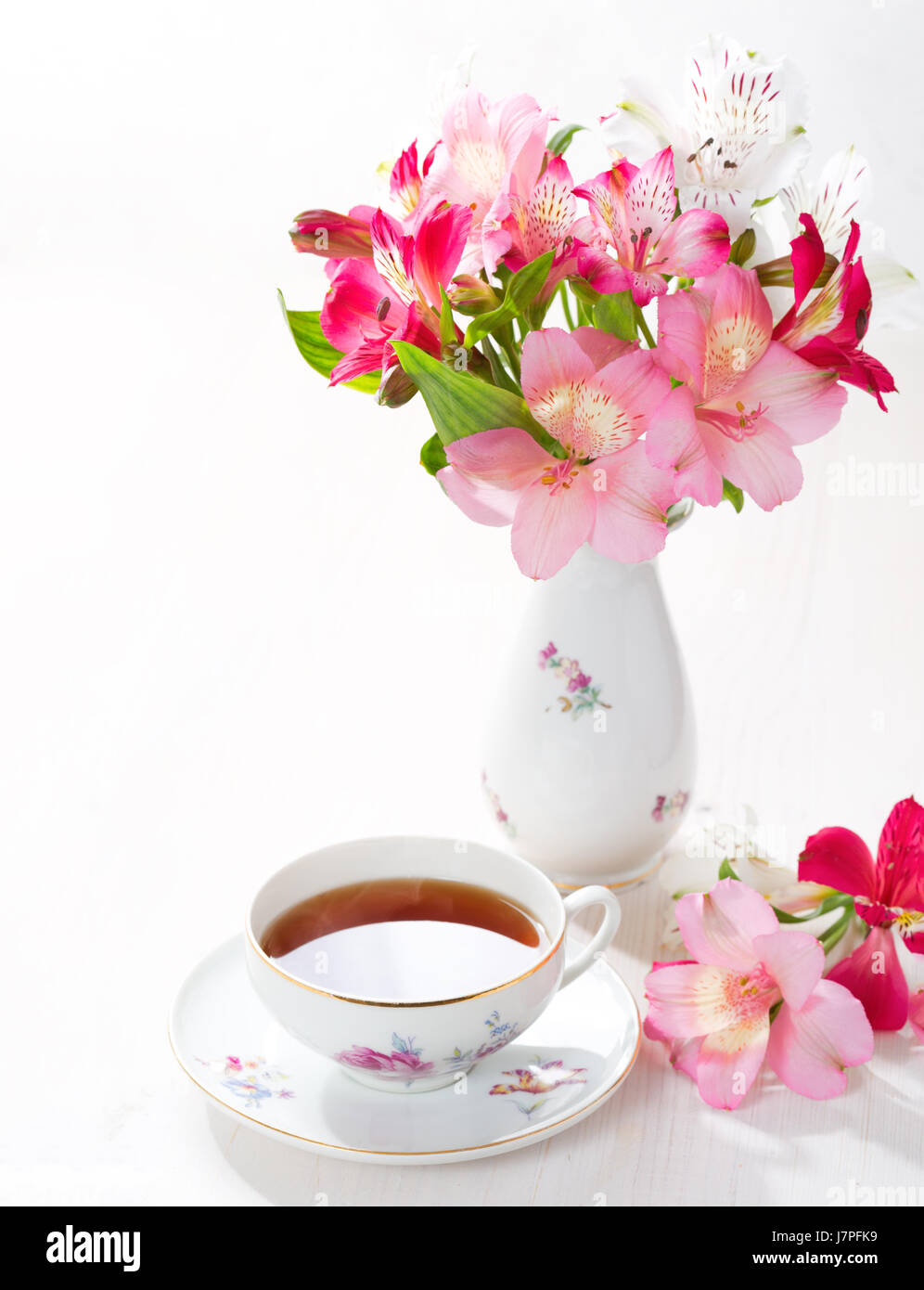 Retro still life with cup of tea and flowers (Alstroemeria Stock Photo ...