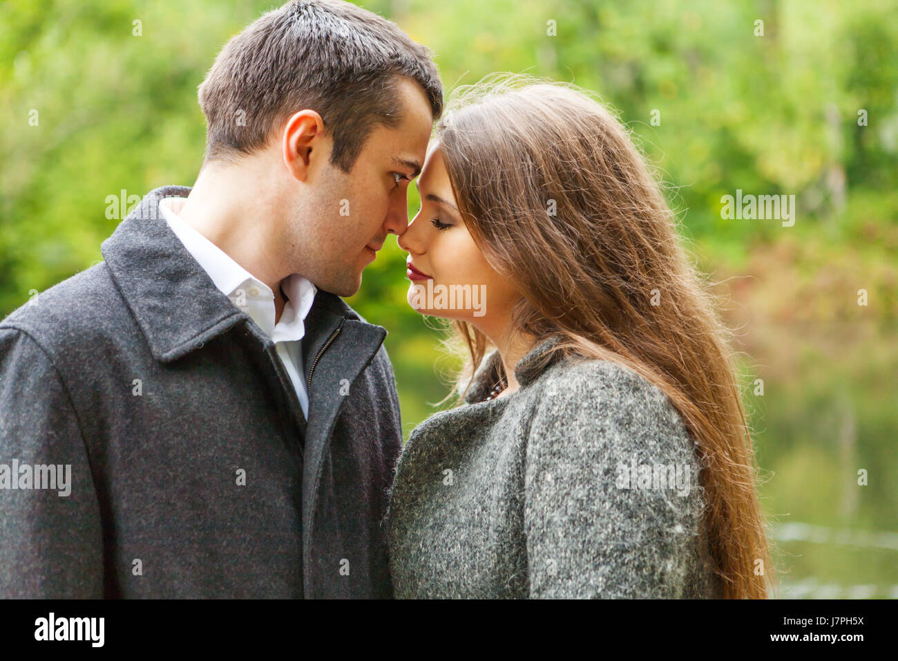 sad young couple in autumn park together faces close Stock Photo - Alamy