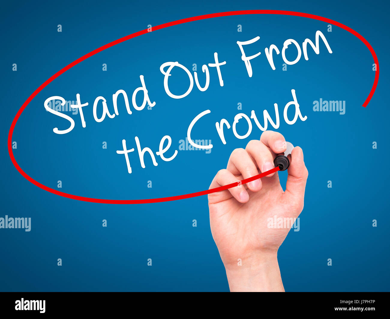 Man Hand writing Stand Out From the Crowd with black marker on visual ...