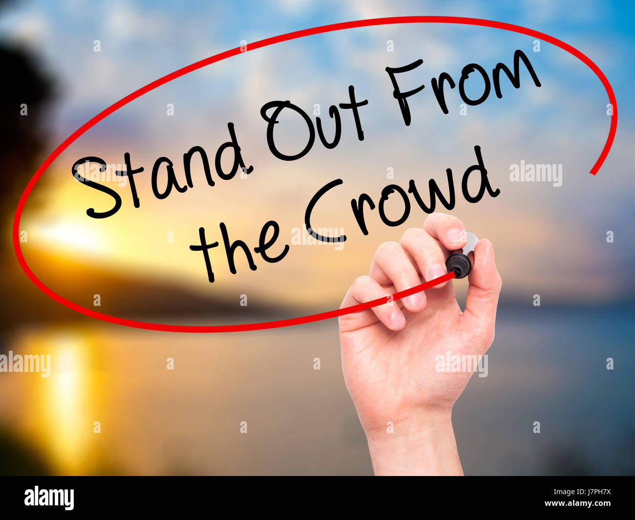 Man Hand writing Stand Out From the Crowd with black marker on visual ...