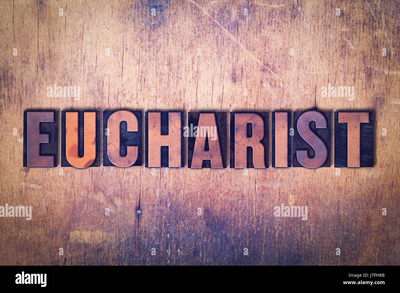The word Eucharist concept and theme written in vintage wooden ...