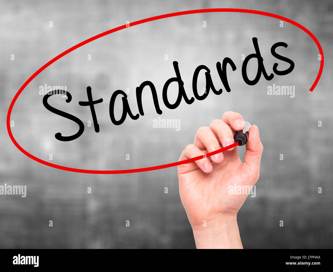 Man Hand writing Standards with black marker on visual screen. Isolated ...
