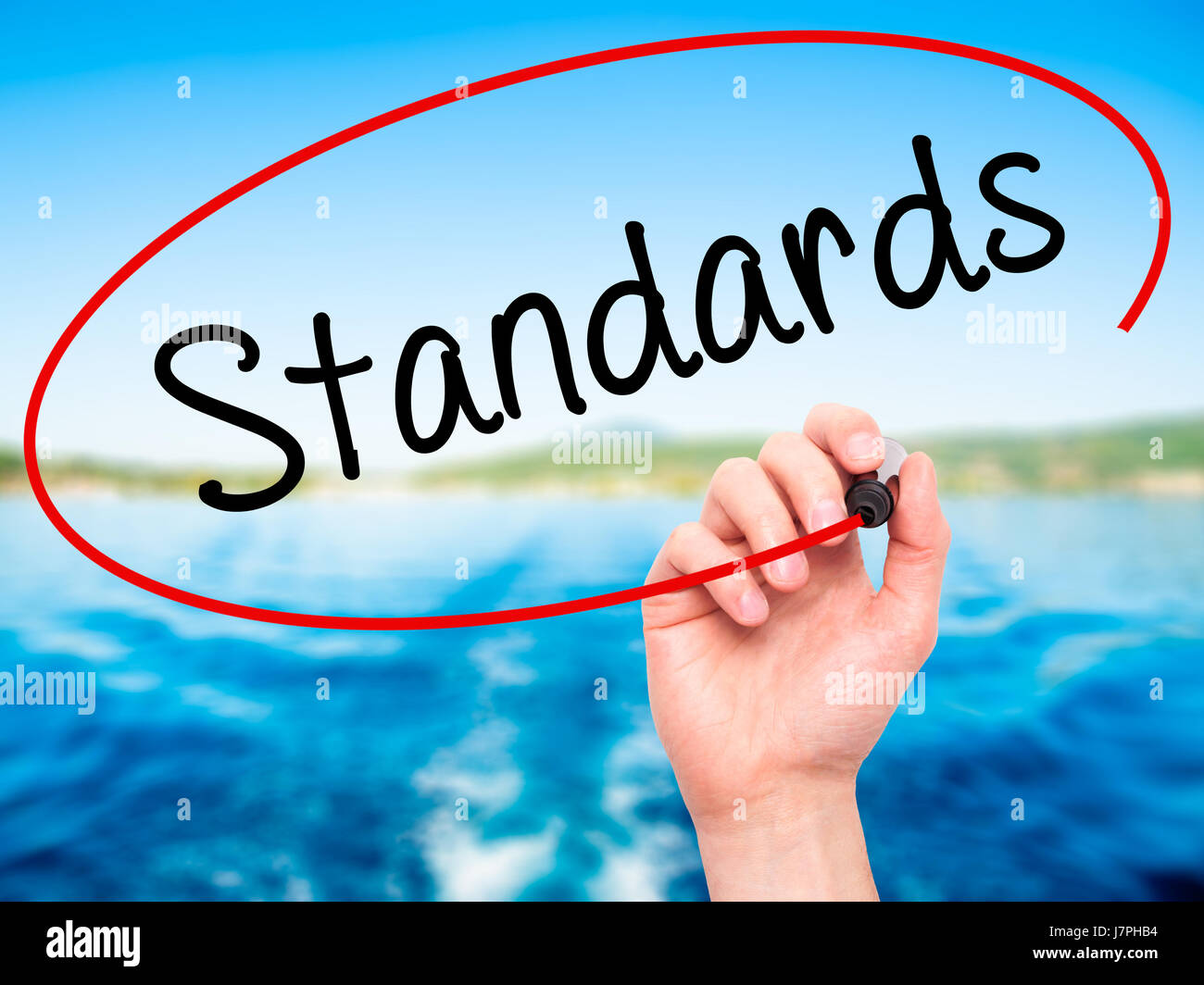 Man Hand writing Standards with black marker on visual screen. Isolated ...