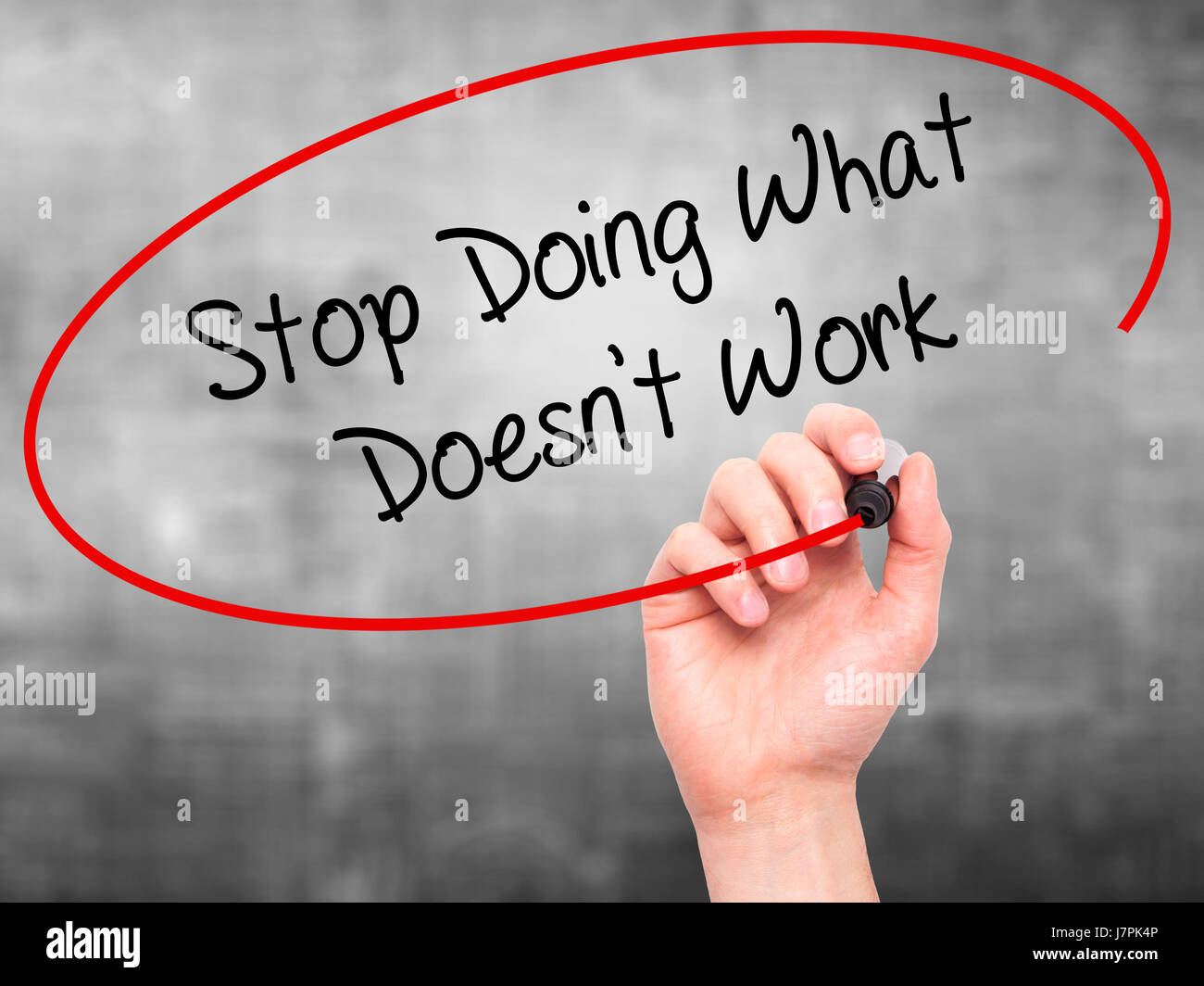 Man Hand writing Stop Doing What Doesn't Work with black marker on ...