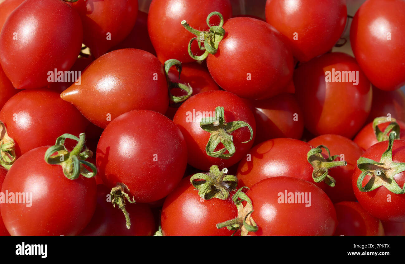 Red tomatoes background. Group of the tomatoes Stock Photo - Alamy