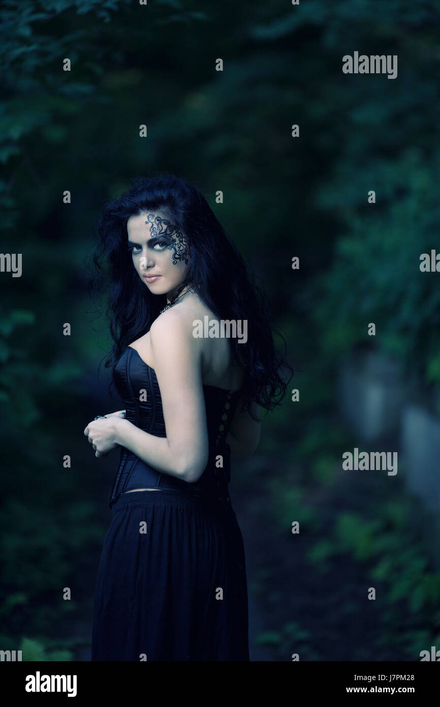 Young beautiful demonic female creature walking through the night Stock ...