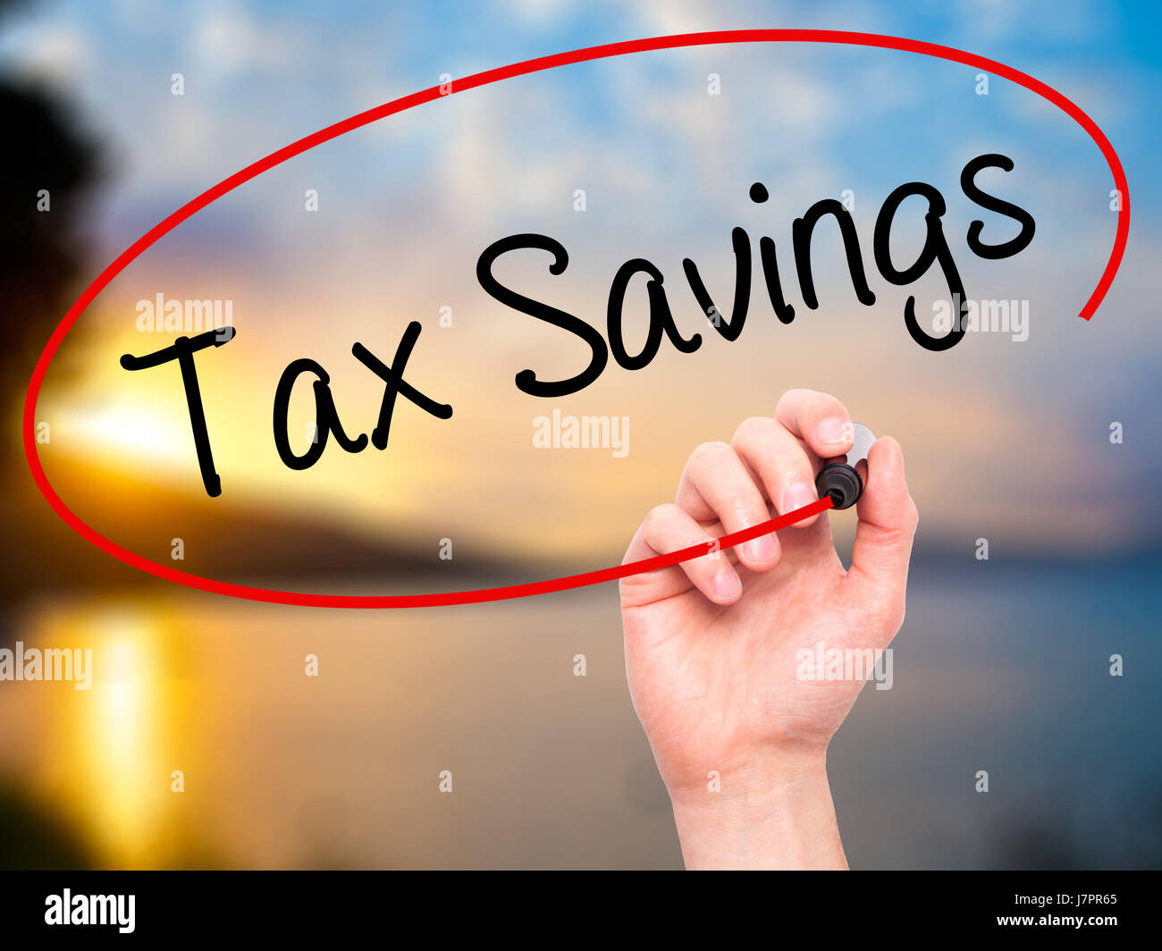 Man Hand writing Tax Savings with black marker on visual screen ...