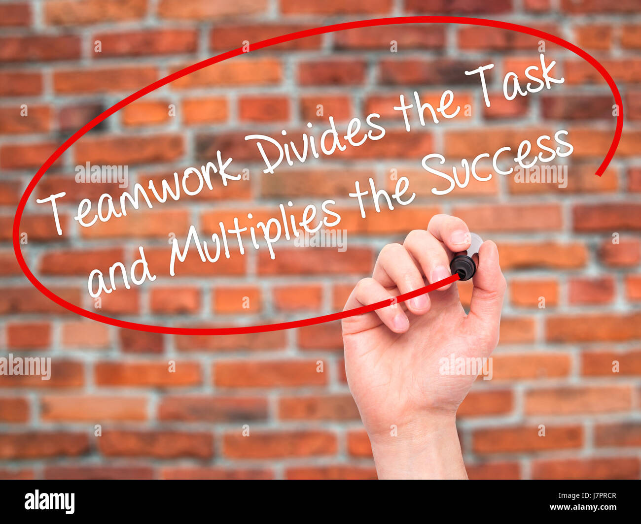 Man Hand writing Teamwork Divides the Task and Multiplies the Success ...