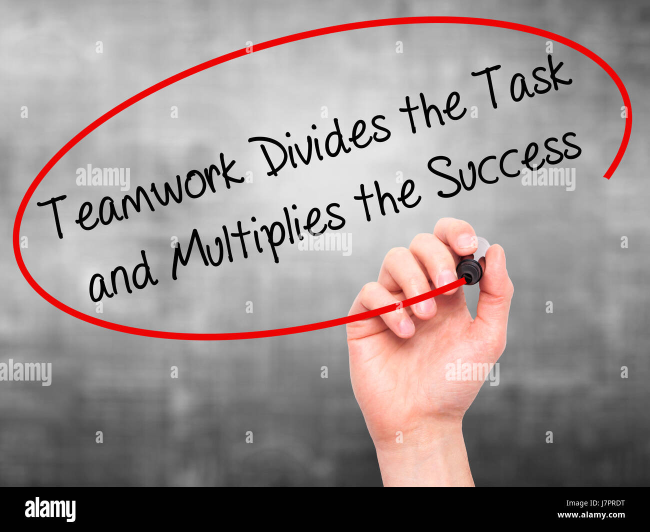 Man Hand writing Teamwork Divides the Task and Multiplies the Success ...