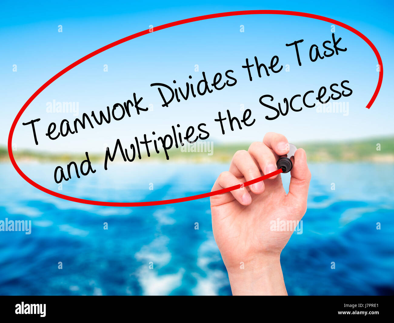 Man Hand writing Teamwork Divides the Task and Multiplies the Success ...