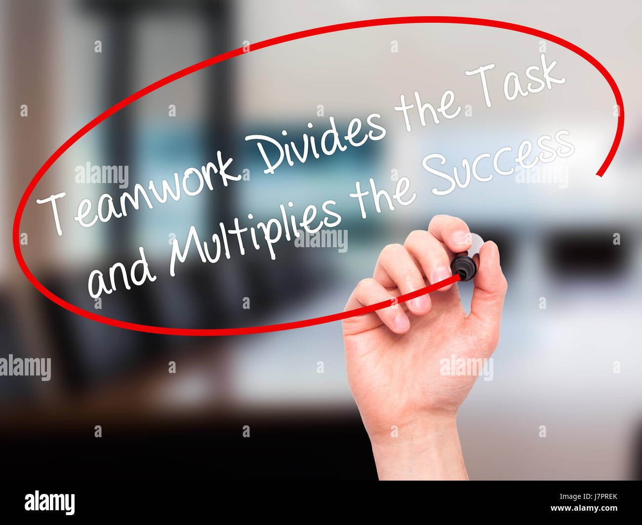 Man Hand writing Teamwork Divides the Task and Multiplies the Success ...