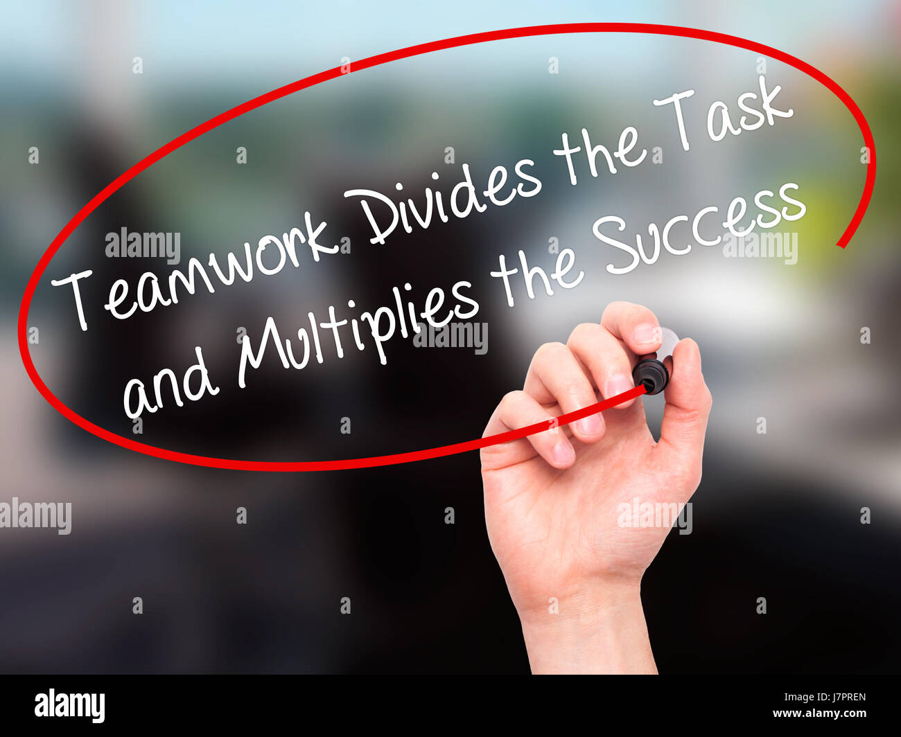 Man Hand writing Teamwork Divides the Task and Multiplies the Success ...