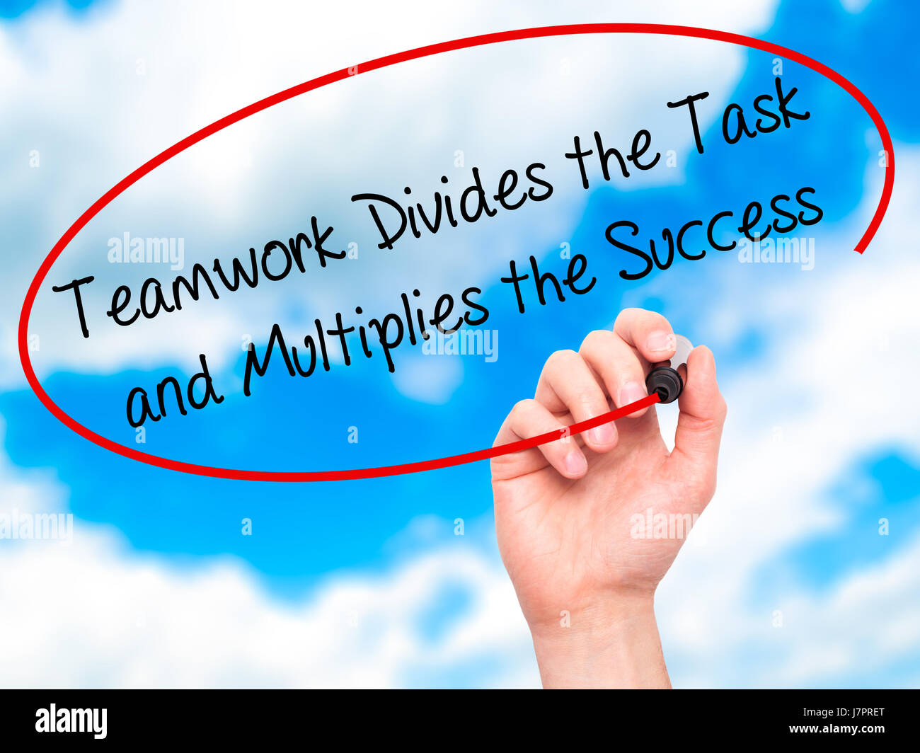 Man Hand writing Teamwork Divides the Task and Multiplies the Success ...