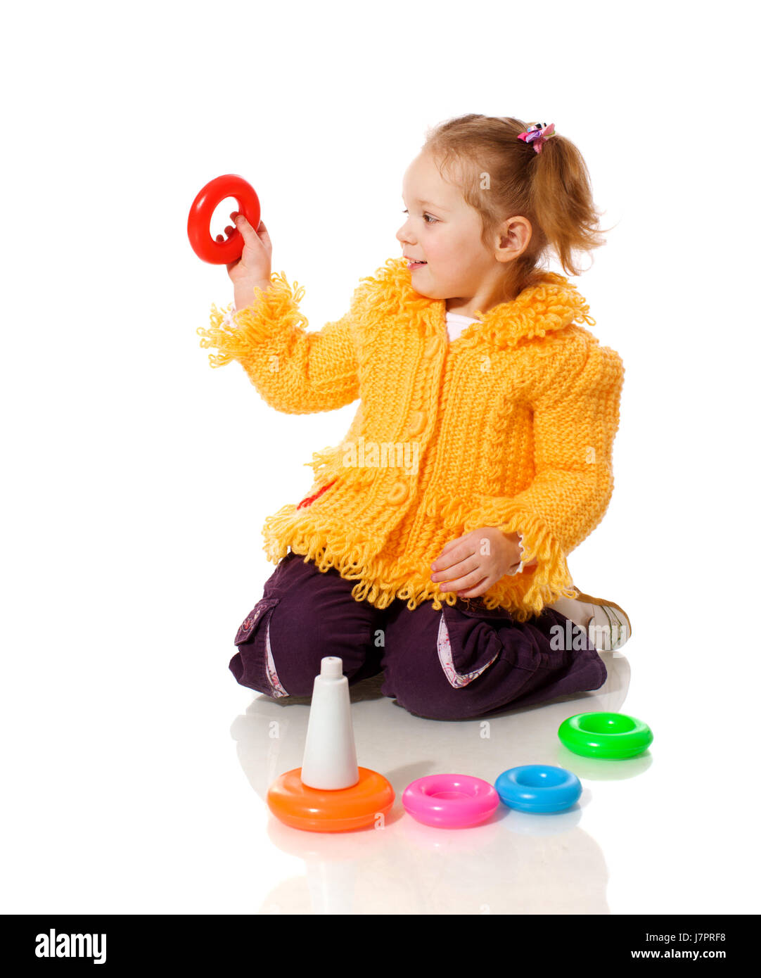 Happy Little Girl playing isolated on white Stock Photo - Alamy