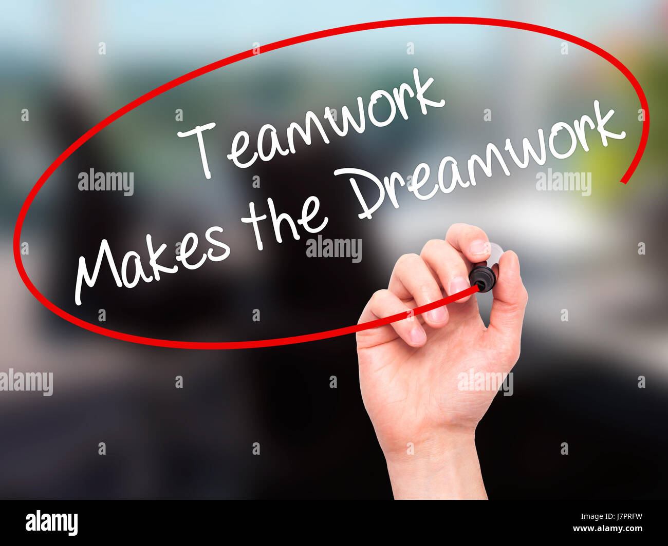 Man Hand writing Teamwork Makes the Dreamwork with black marker on ...