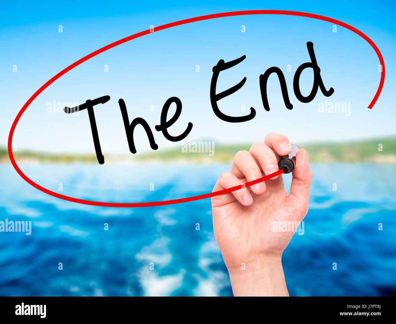 Man Hand writing The End with black marker on visual screen. Isolated ...