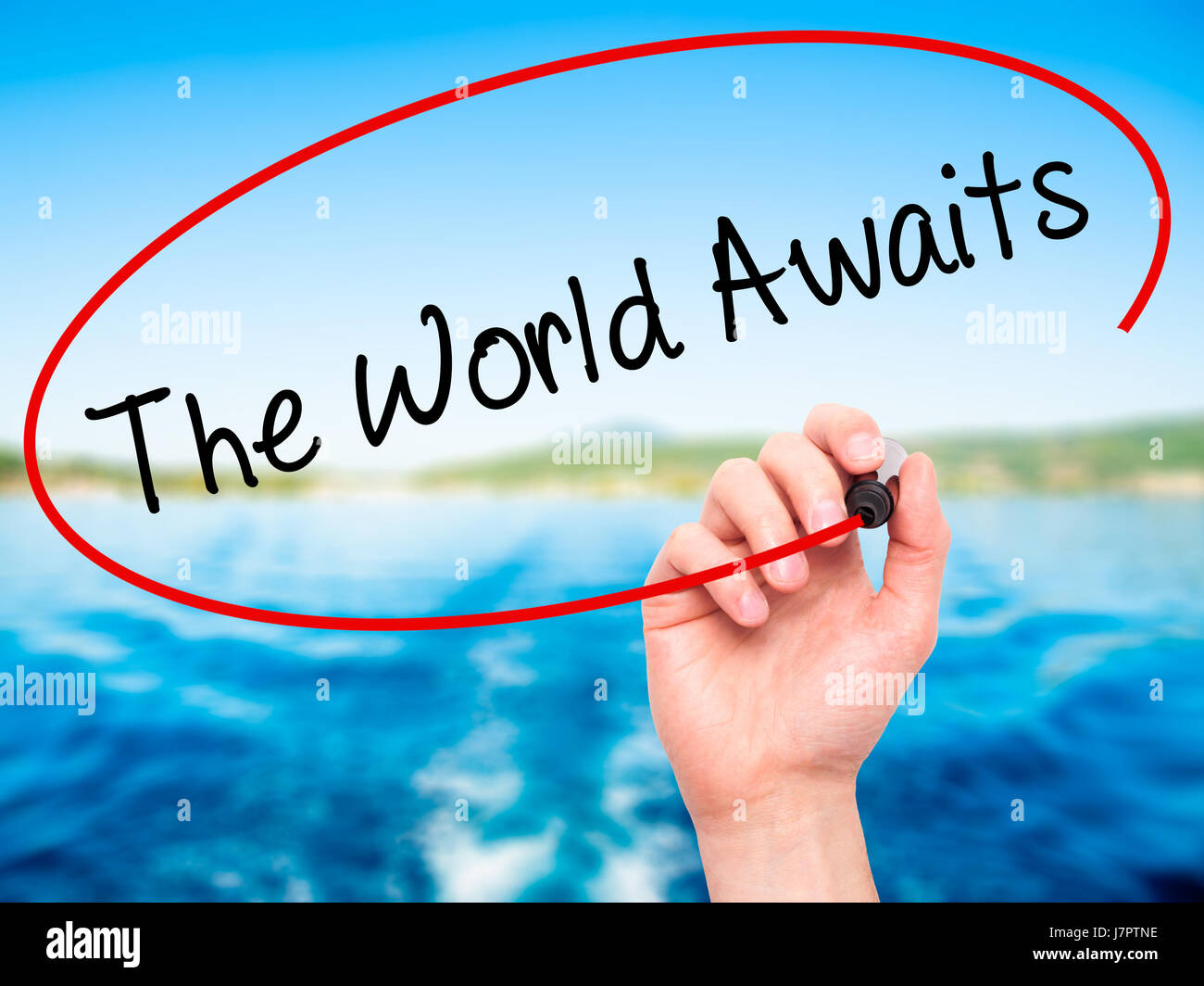 Man Hand writing The World Awaits with black marker on visual screen ...