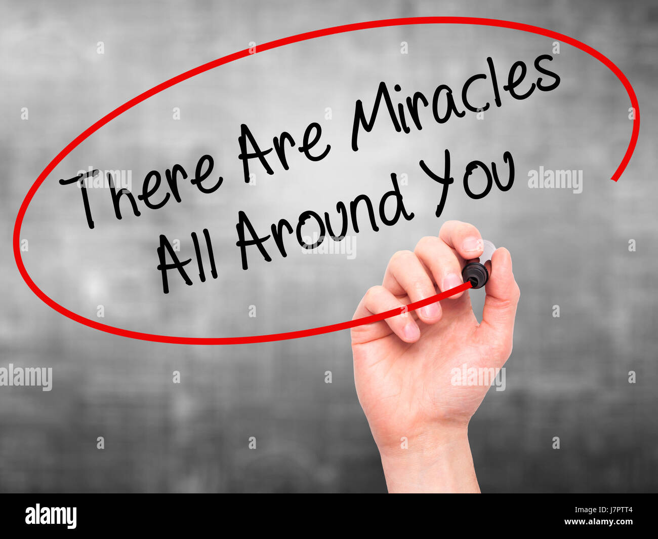 Man Hand writing There Are Miracles All Around You with black marker on ...