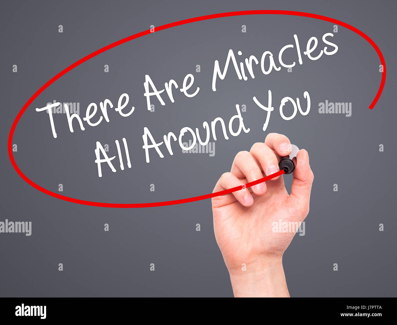 Man Hand writing There Are Miracles All Around You with black marker on ...