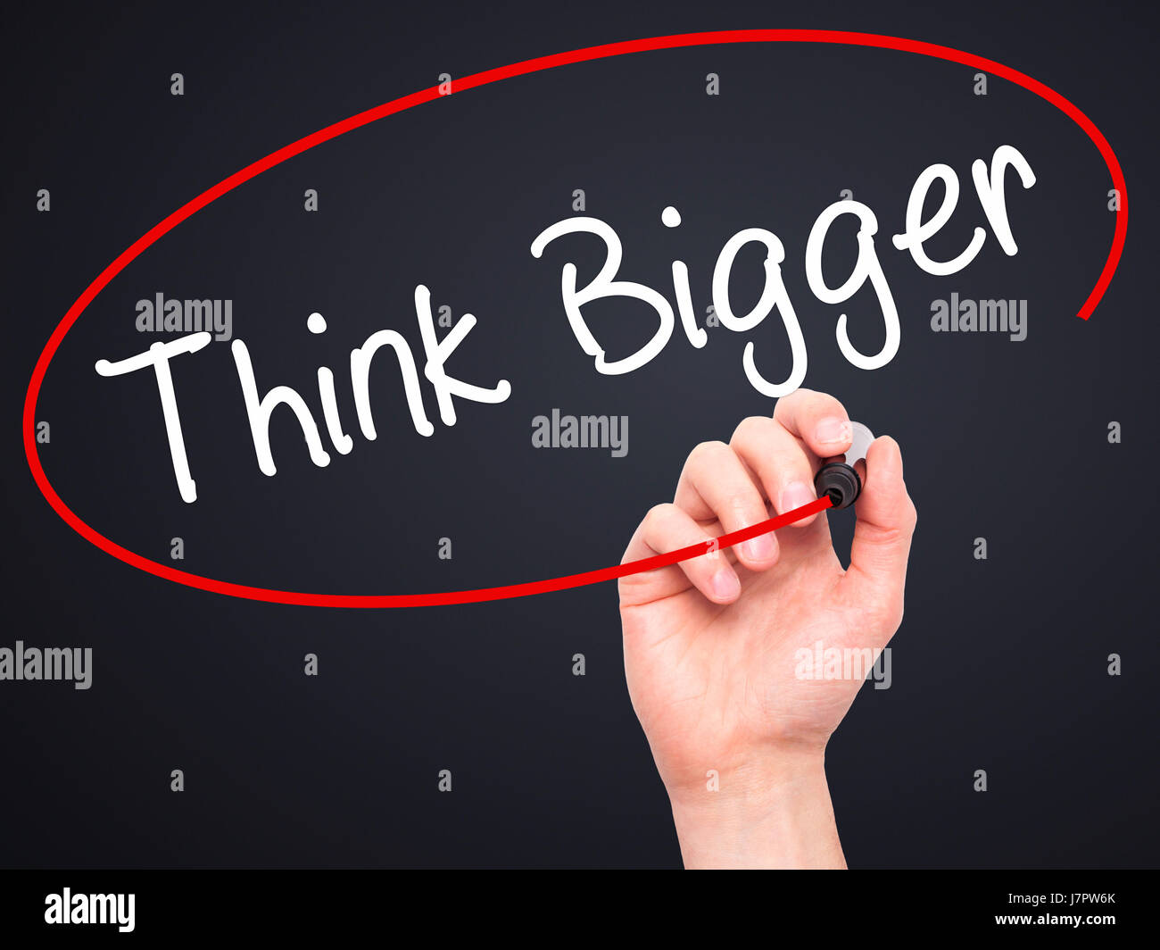 Man Hand writing Think Bigger with black marker on visual screen ...