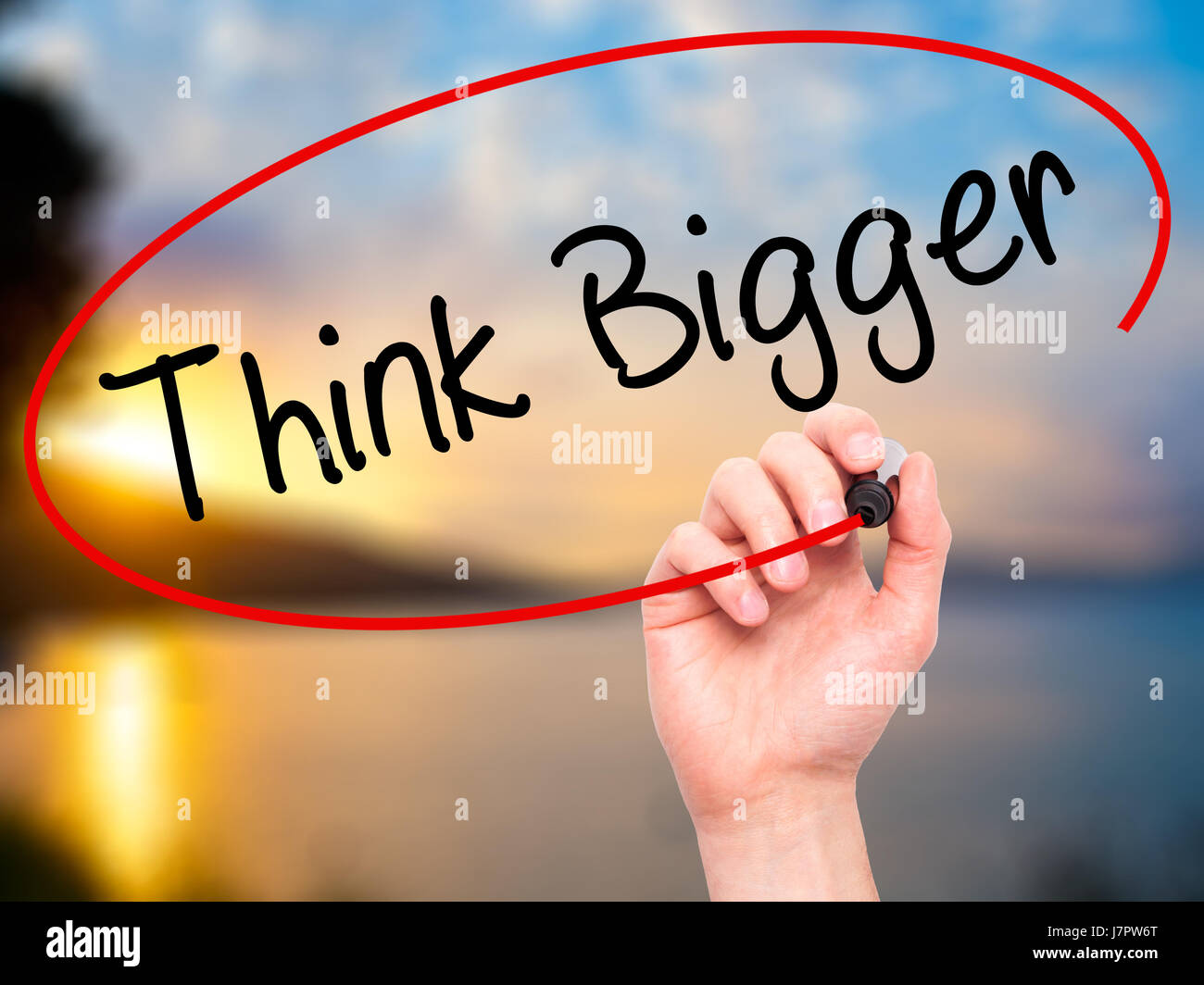 Man Hand writing Think Bigger with black marker on visual screen ...