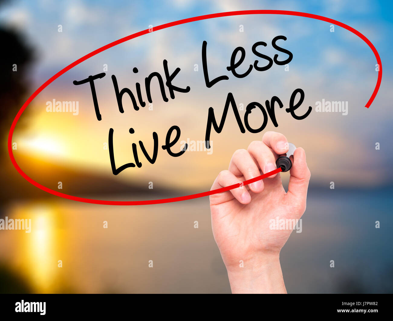 Man Hand writing Think Less Live More with black marker on visual ...