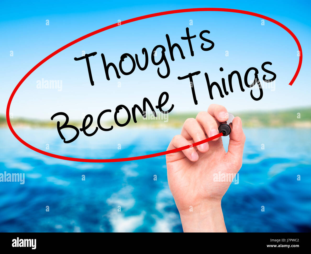 Man Hand writing Thoughts Become Things with black marker on visual ...