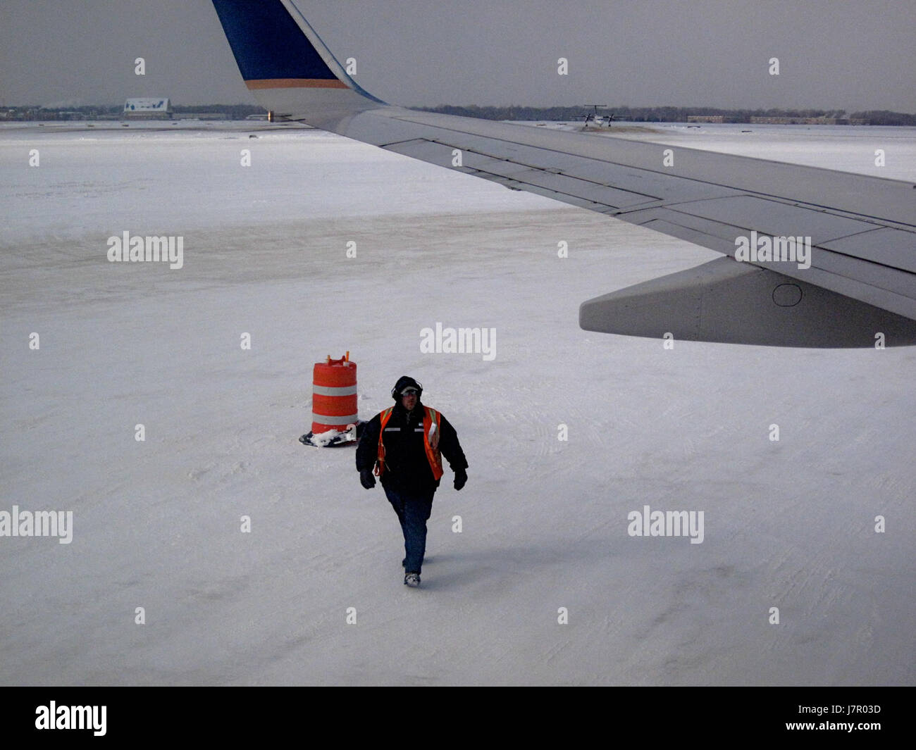 This image depicts a plane landing on a frozen runway, highlighting the ...