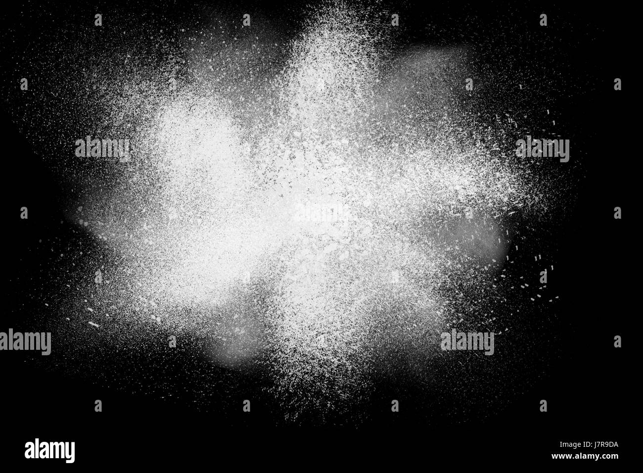 Freeze motion of white powder exploding, isolated on black, dark ...