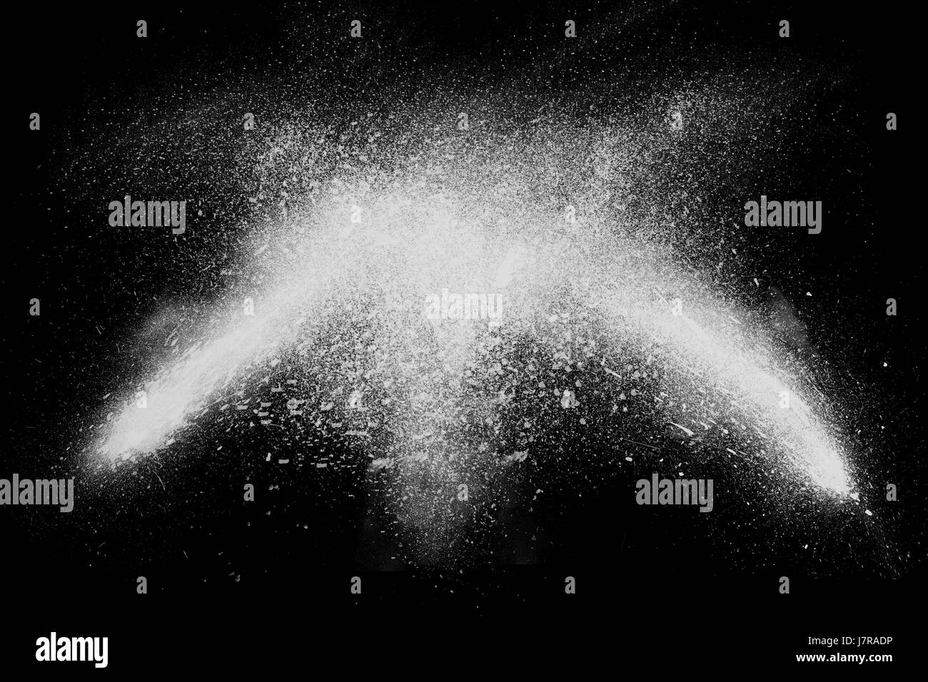 Freeze motion of white powder exploding, isolated on black, dark ...