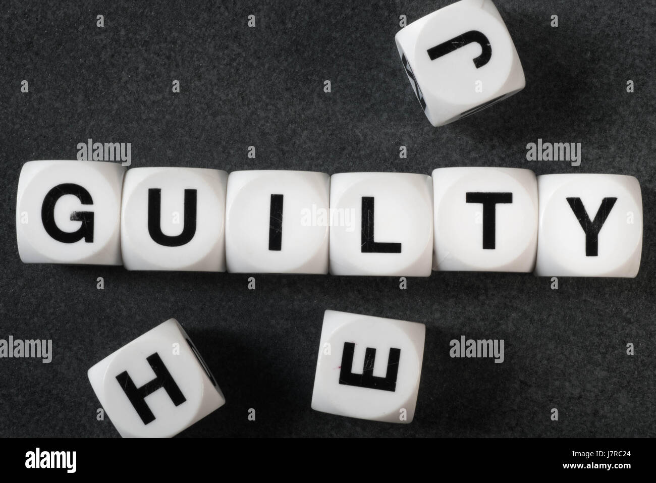 word guilty on white toy cubes Stock Photo - Alamy