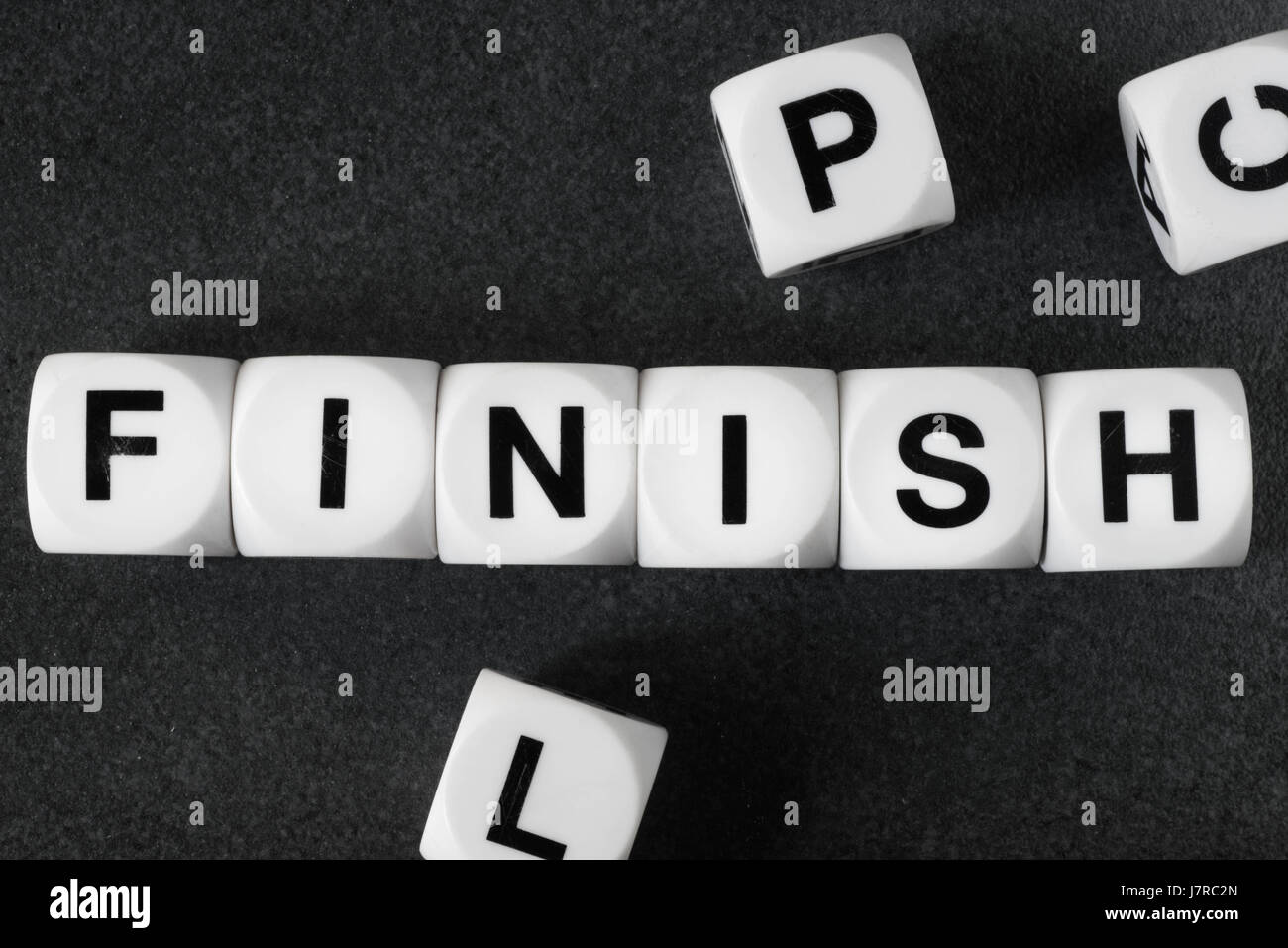 word finish on white toy cubes Stock Photo - Alamy