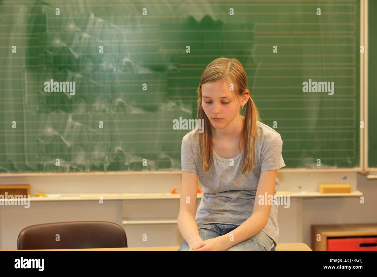 Teacher alone in classroom sad hi-res stock photography and images - Alamy