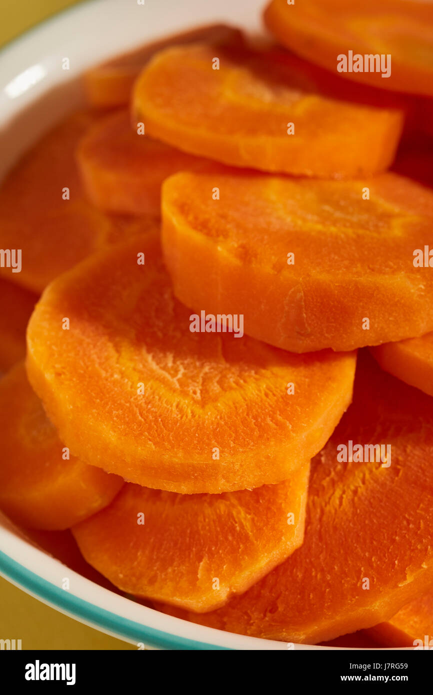 poached sliced carrots, sometimes called carrot coins Stock Photo - Alamy