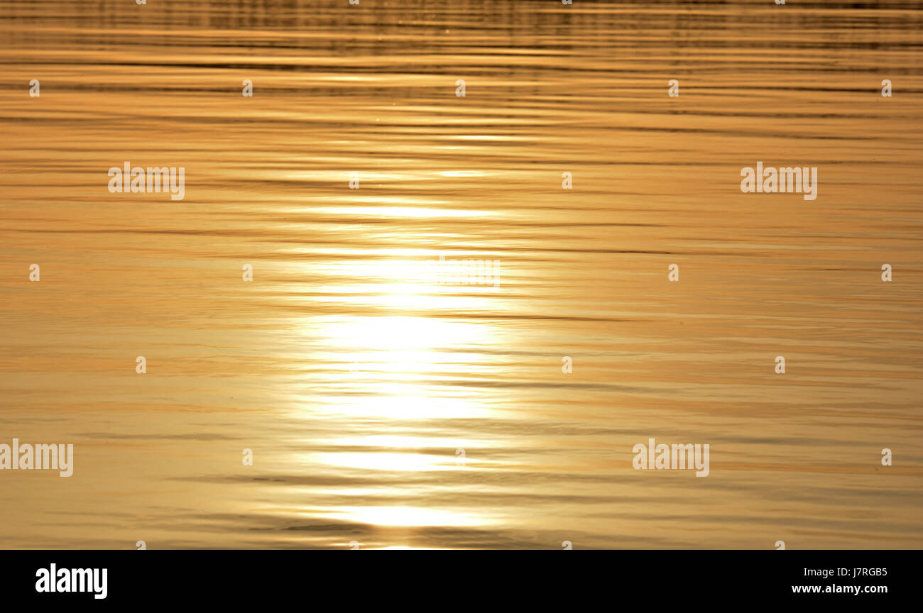 Nature abstract background. Sunrise reflection on the water surface ...